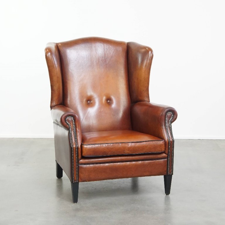 Sheep leather ear chair with a warm color scheme and a finish with ...
