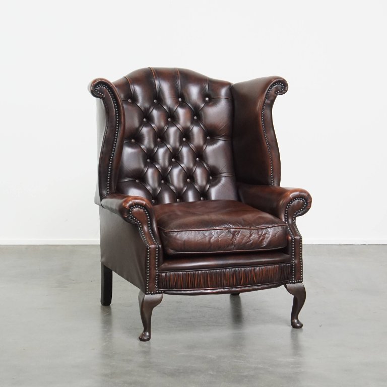 Brown cowhide leather chesterfield ear chair | €1,000 | Whoppah